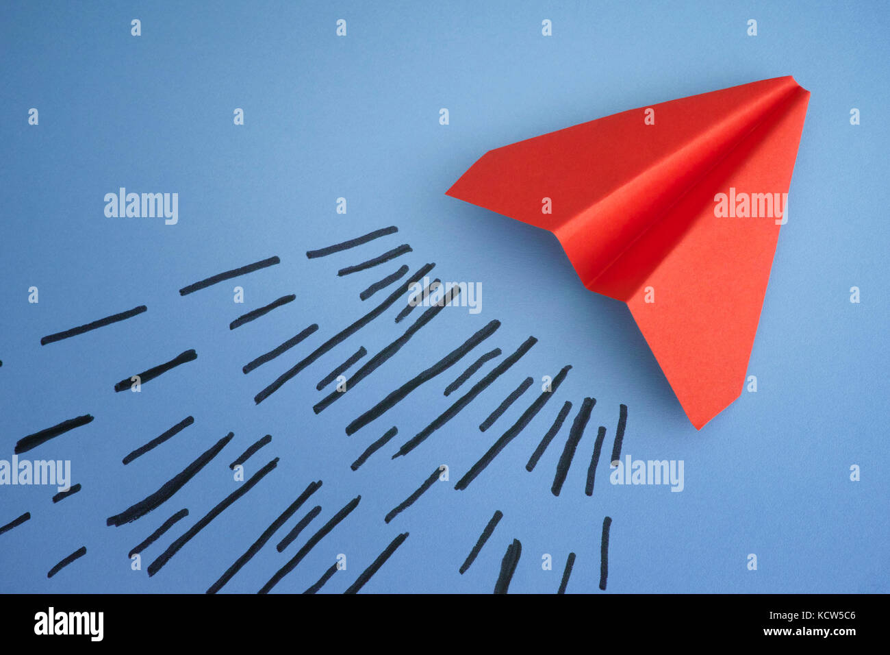 Red paper plane on a blue background. Close up Stock Photo - Alamy