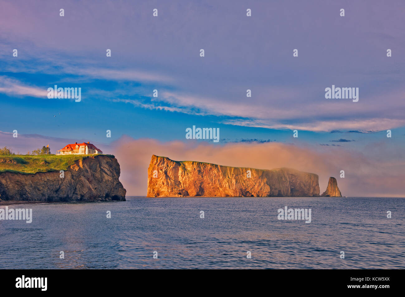 Roche Perce and Atlantic Ocean sin fog at sunrise on Gaspe Peninsula ...