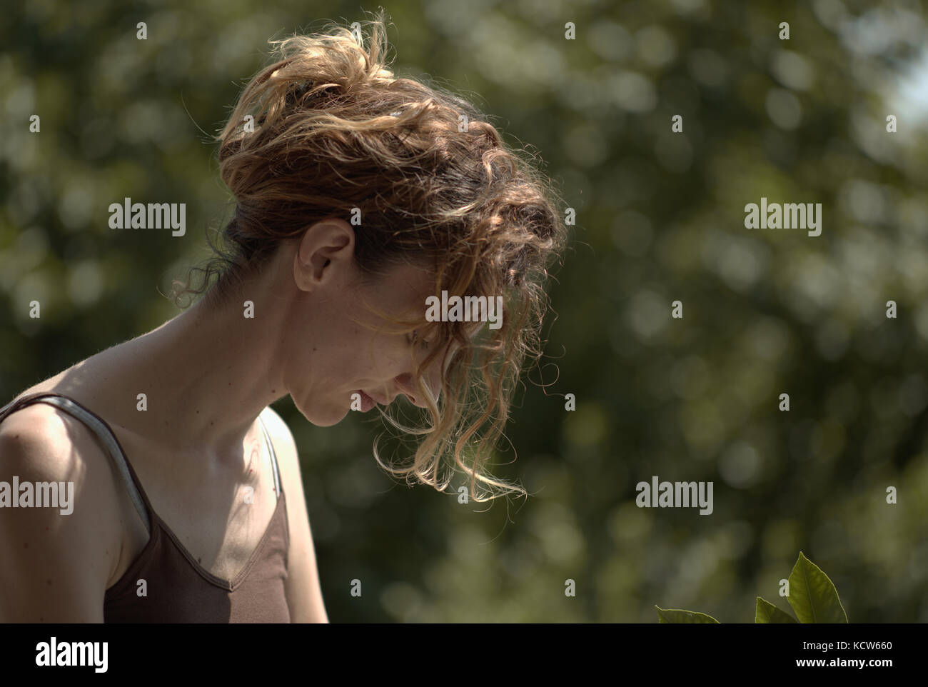Young woman thinking, on blurred nature background Stock Photo - Alamy