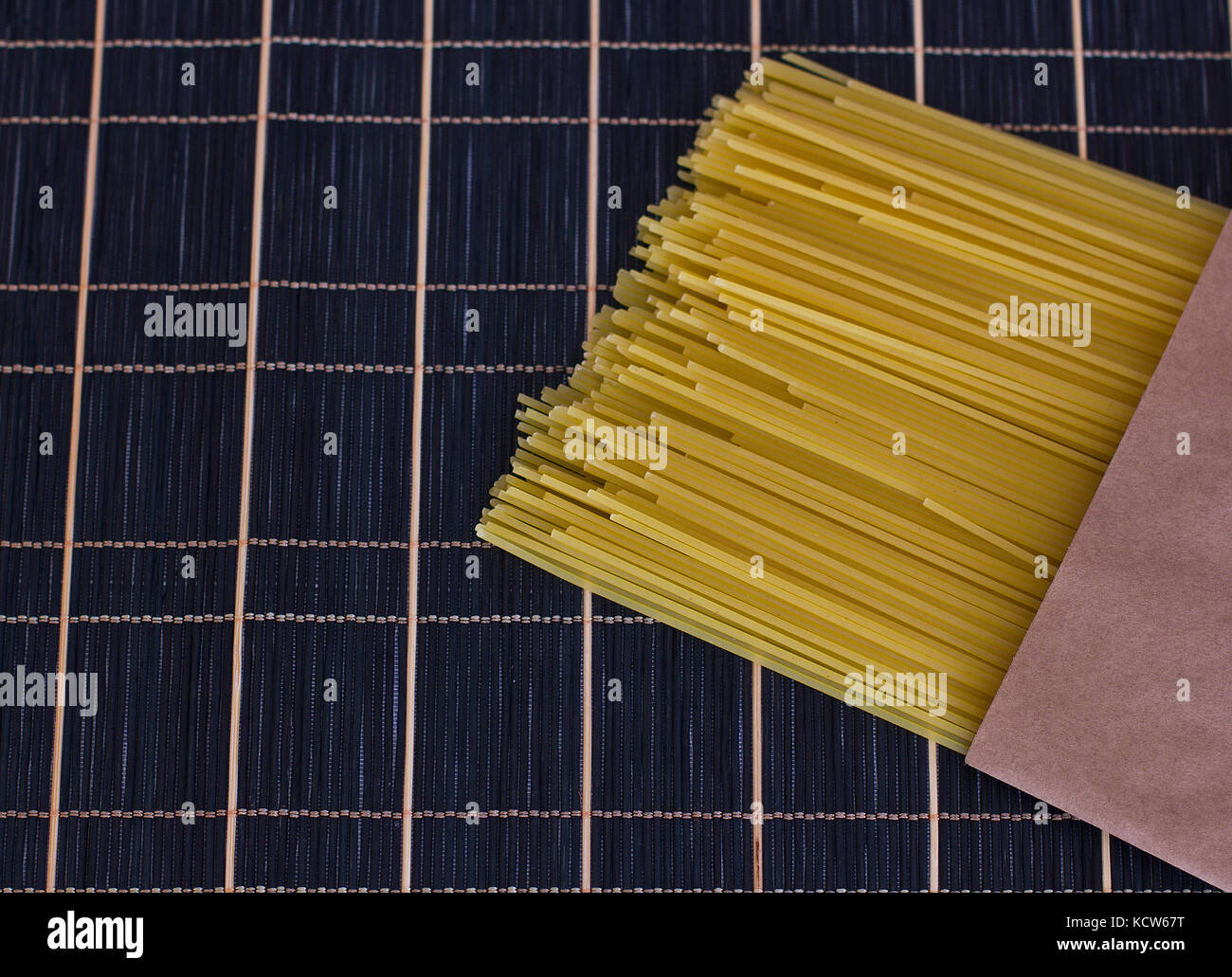 Spaghetti in brown paper bag on a checkered dark table Stock Photo - Alamy