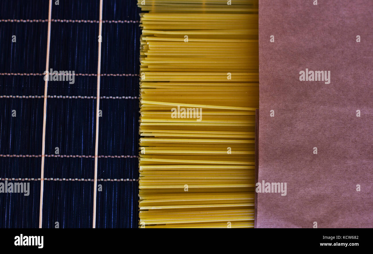 Spaghetti in brown paper bag on a checkered dark table Stock Photo - Alamy