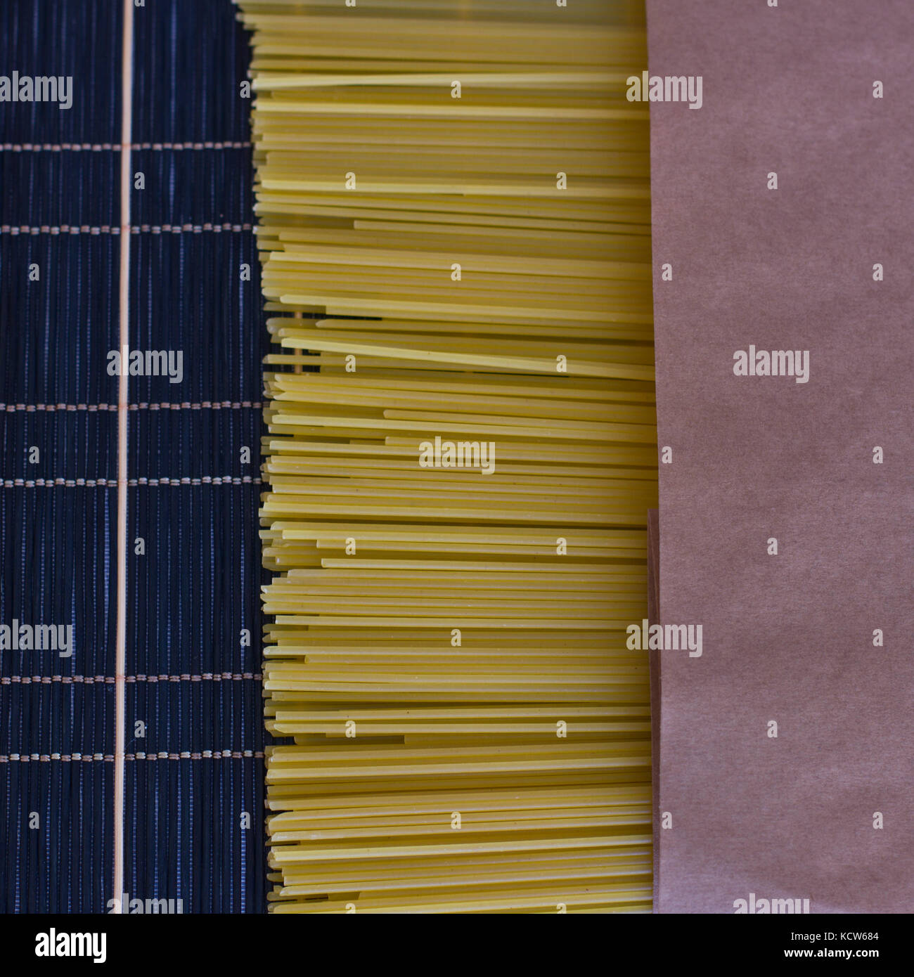 Spaghetti in brown paper bag on a checkered dark table Stock Photo - Alamy