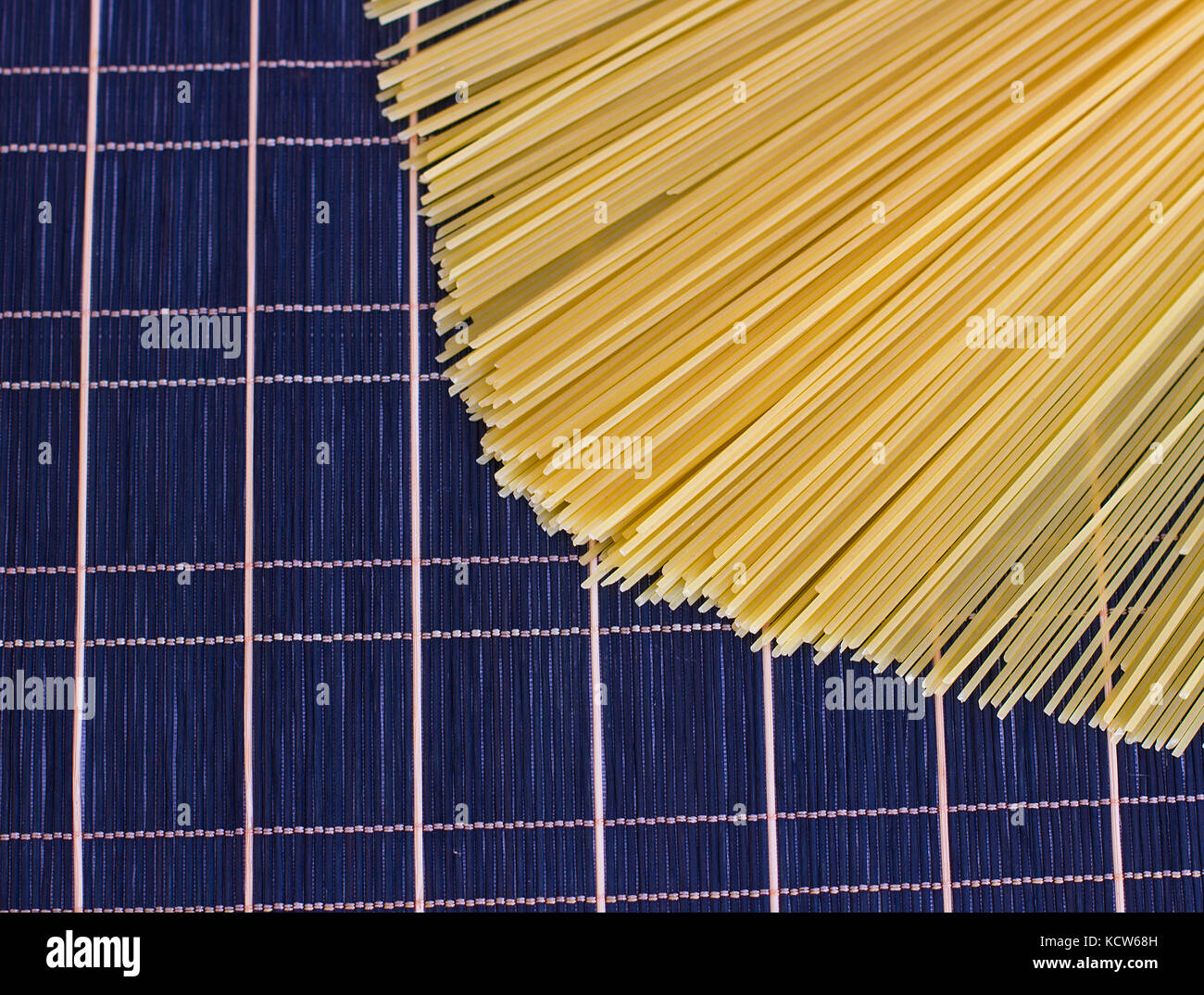 Raw spaghetti on a checkered dark table Stock Photo - Alamy