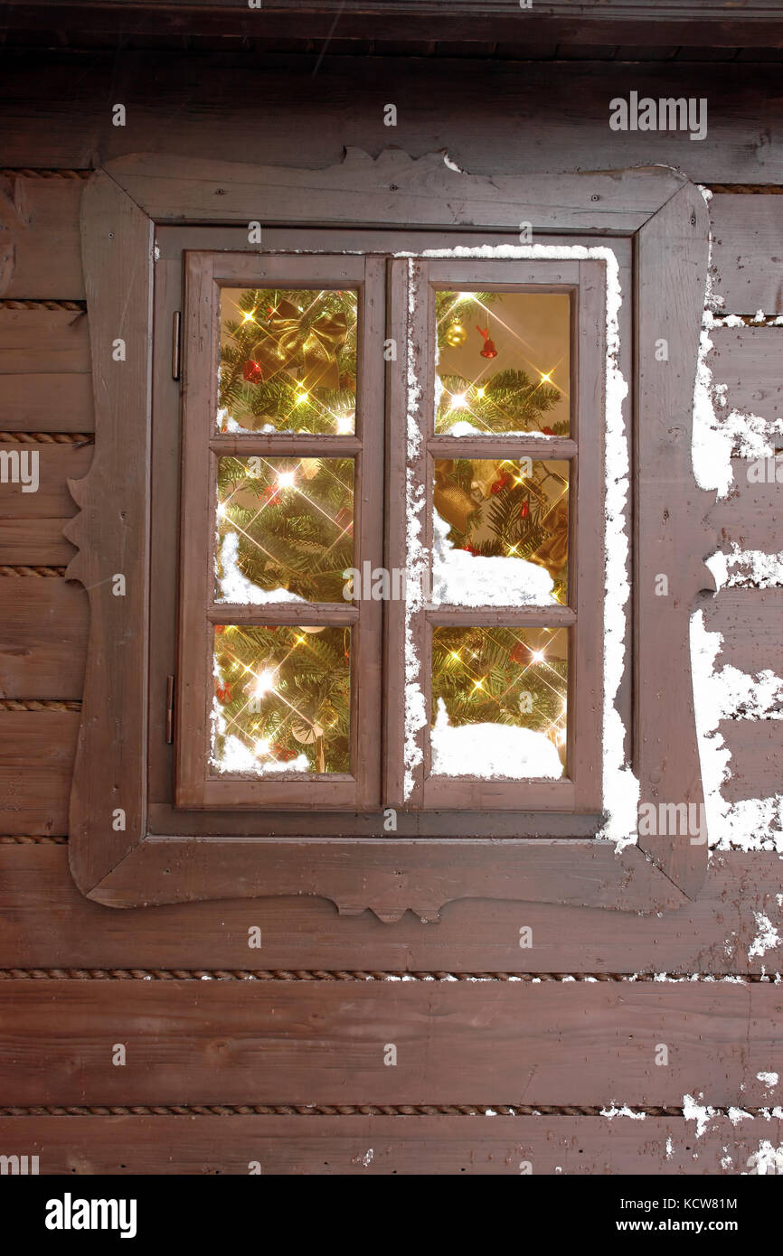 Christmas tree with lights seen through a wooden cabin window Stock ...