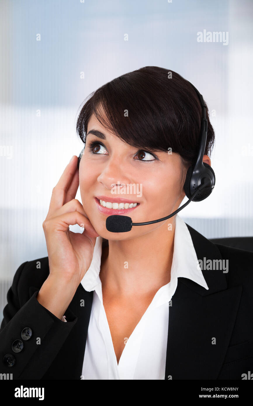 Happy Young Female Callcenter Employee Wearing Headset In Office Stock ...
