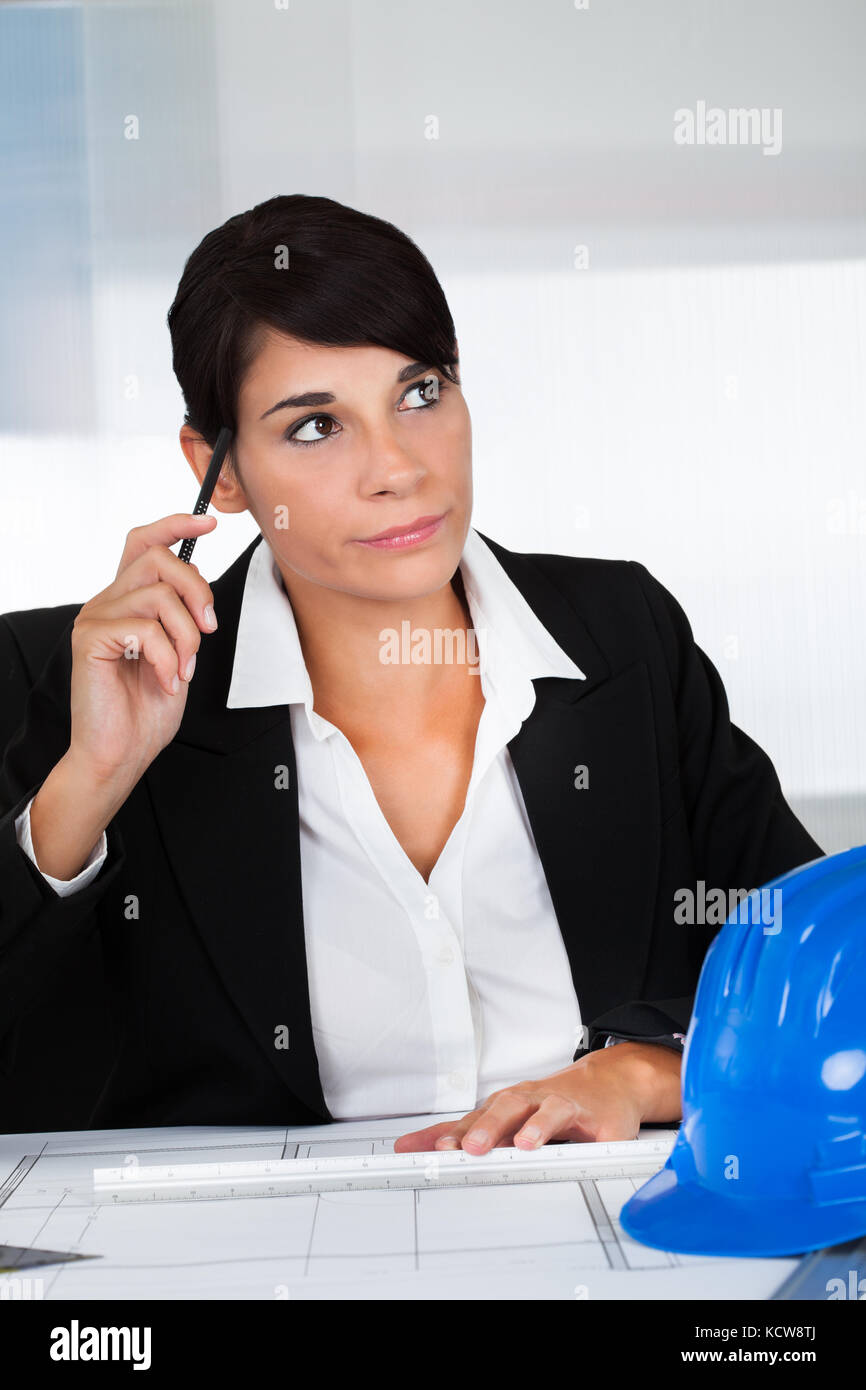Young Happy Female Architect Working On Blue Print In Office Stock ...