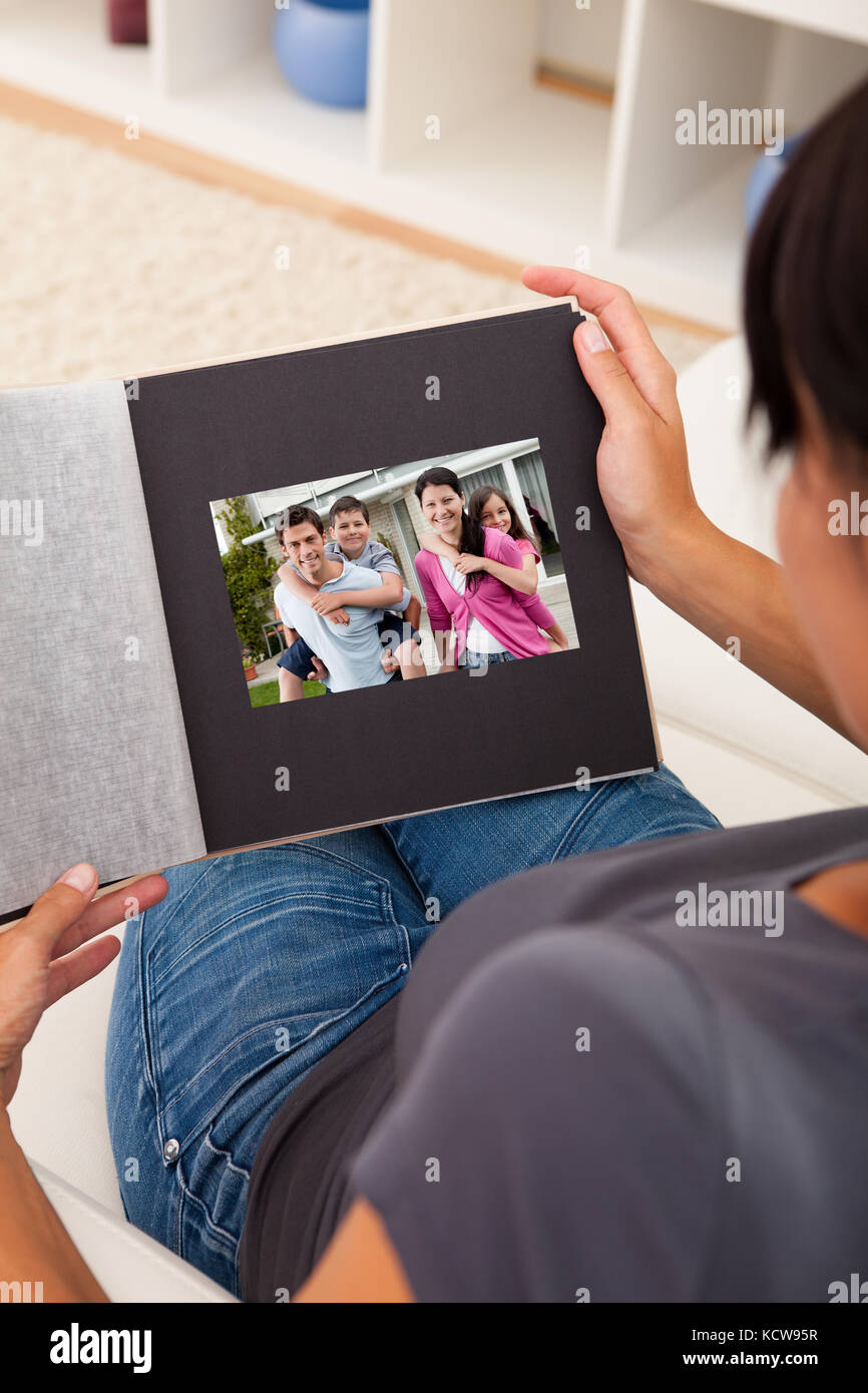 Close-up Of Woman Looking Through Photo Album; Indoors Stock Photo - Alamy