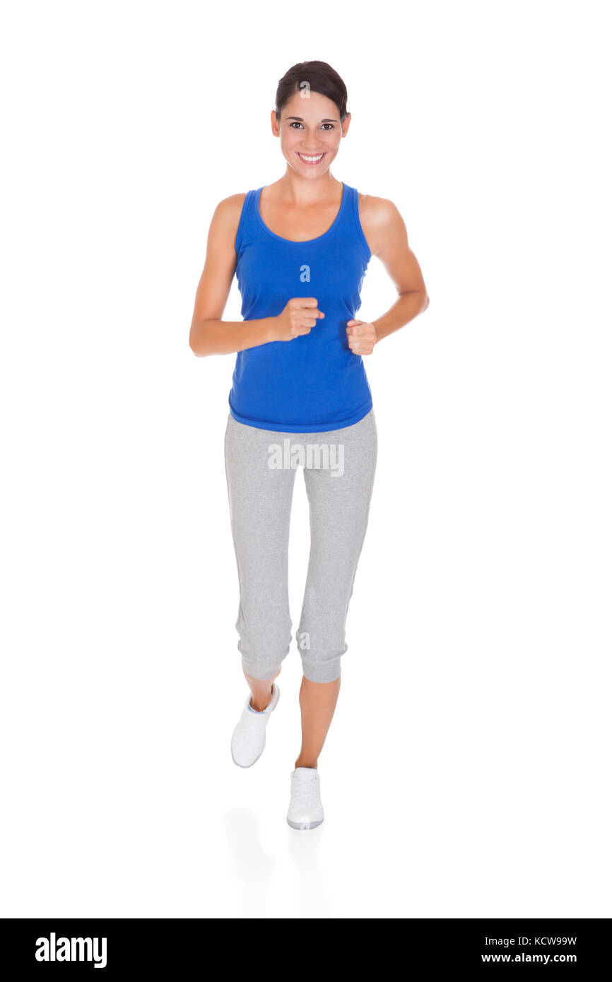 Happy Young Woman Jogging Over White Background Stock Photo - Alamy