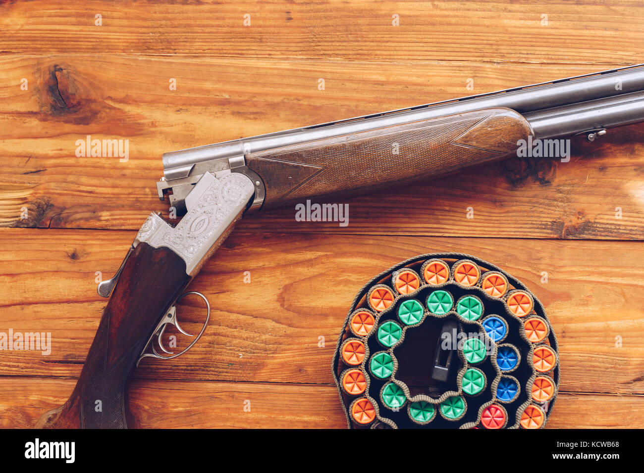 Hunting equipment. Shotgun and hunting cartridges on wooden table Stock ...