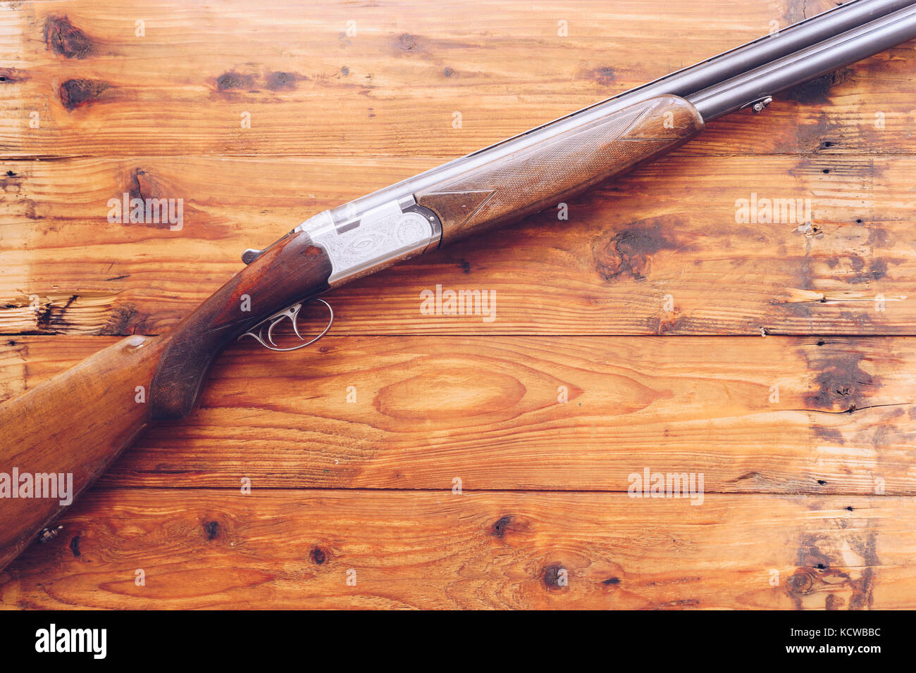 Hunting rifle isolated on wooden background Stock Photo - Alamy