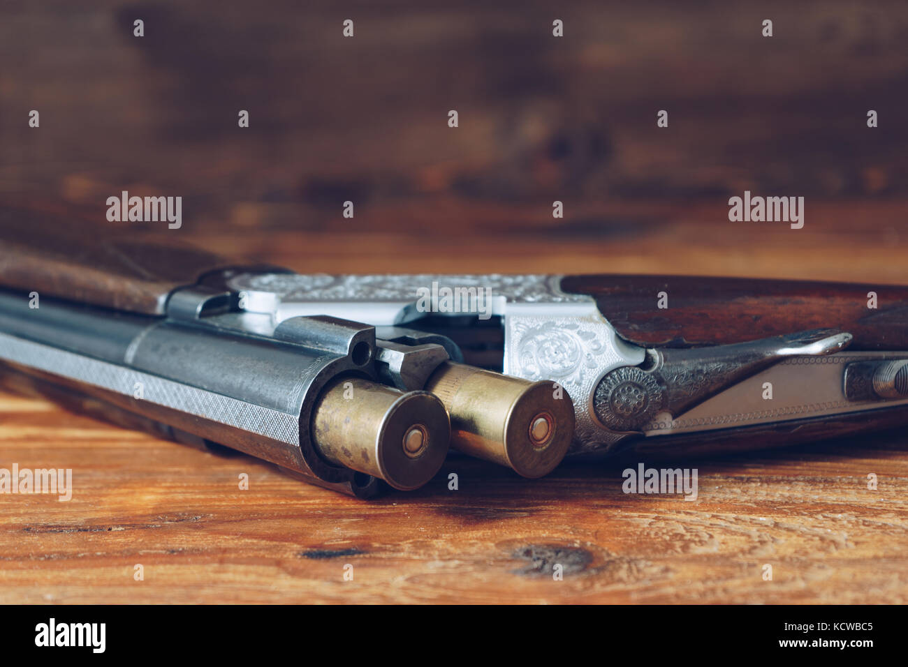 Open hunting rifle isolated on wooden background Stock Photo - Alamy