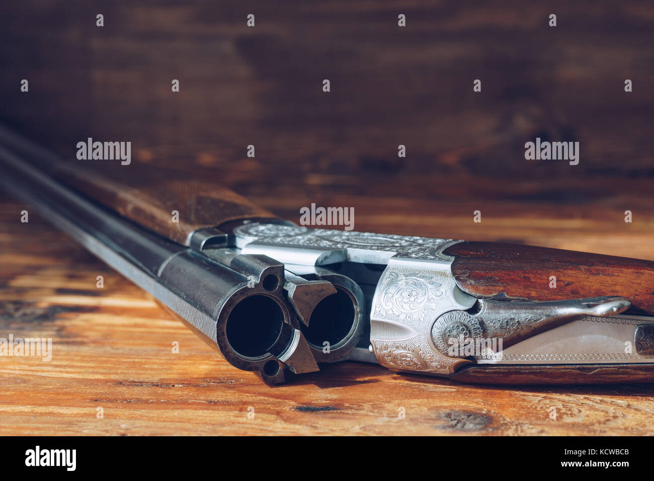 Open hunting rifle isolated on wooden background Stock Photo - Alamy