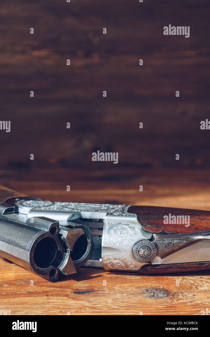 Open hunting rifle isolated on wooden background Stock Photo - Alamy