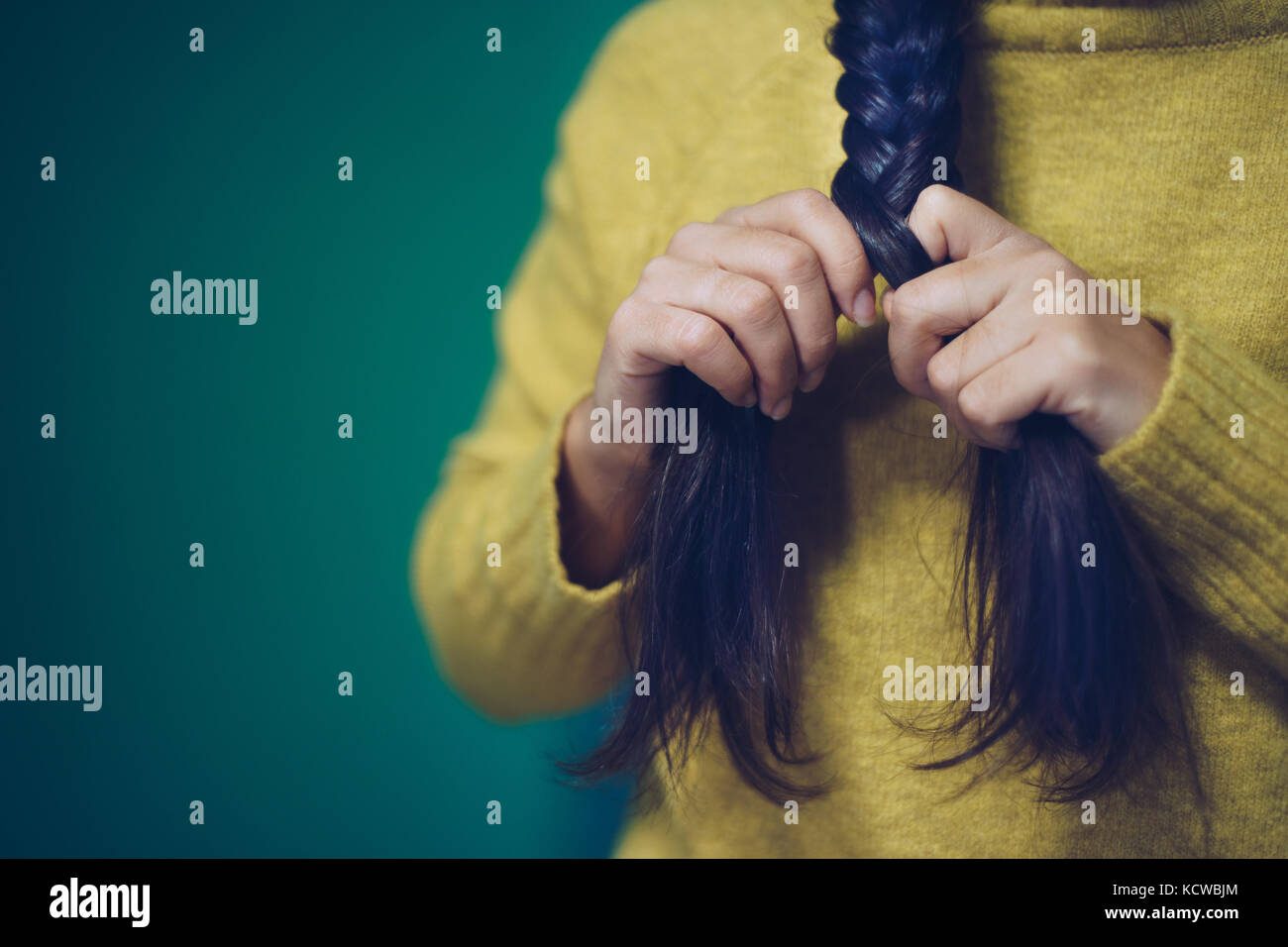 Girl is plaiting her hair Stock Photo - Alamy
