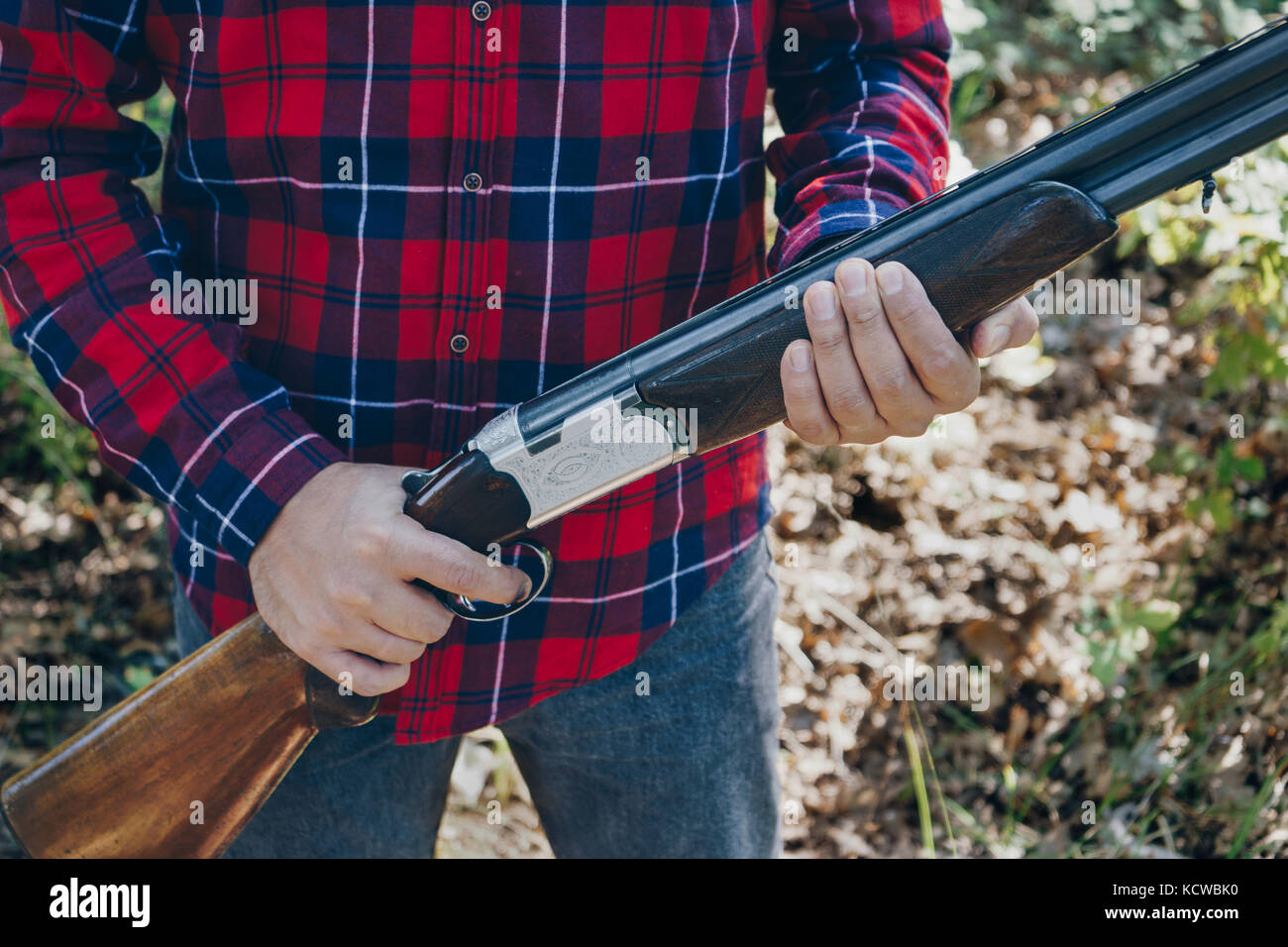 Hunter with a gun on the forest Stock Photo - Alamy