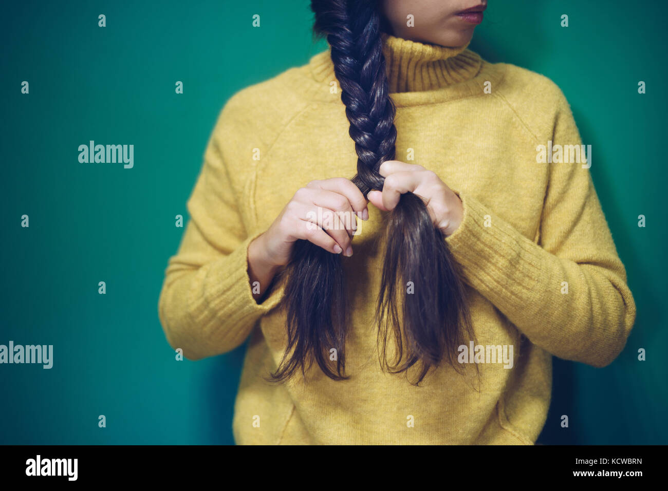 Girl is plaiting her hair Stock Photo - Alamy