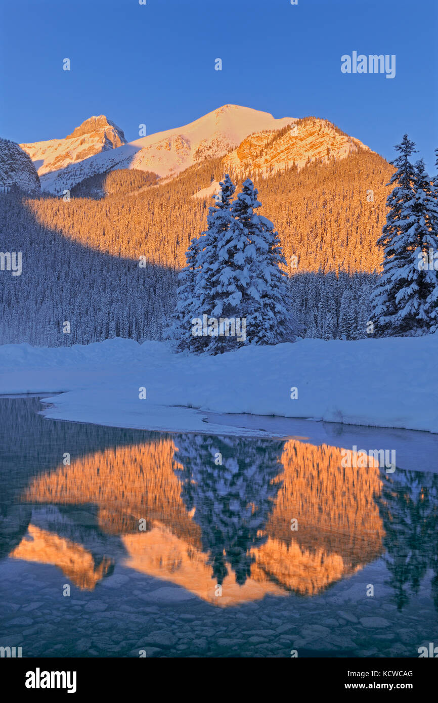 The Canadian Rocky Mountains reflected in Lake Louise at sunrise, Banff ...