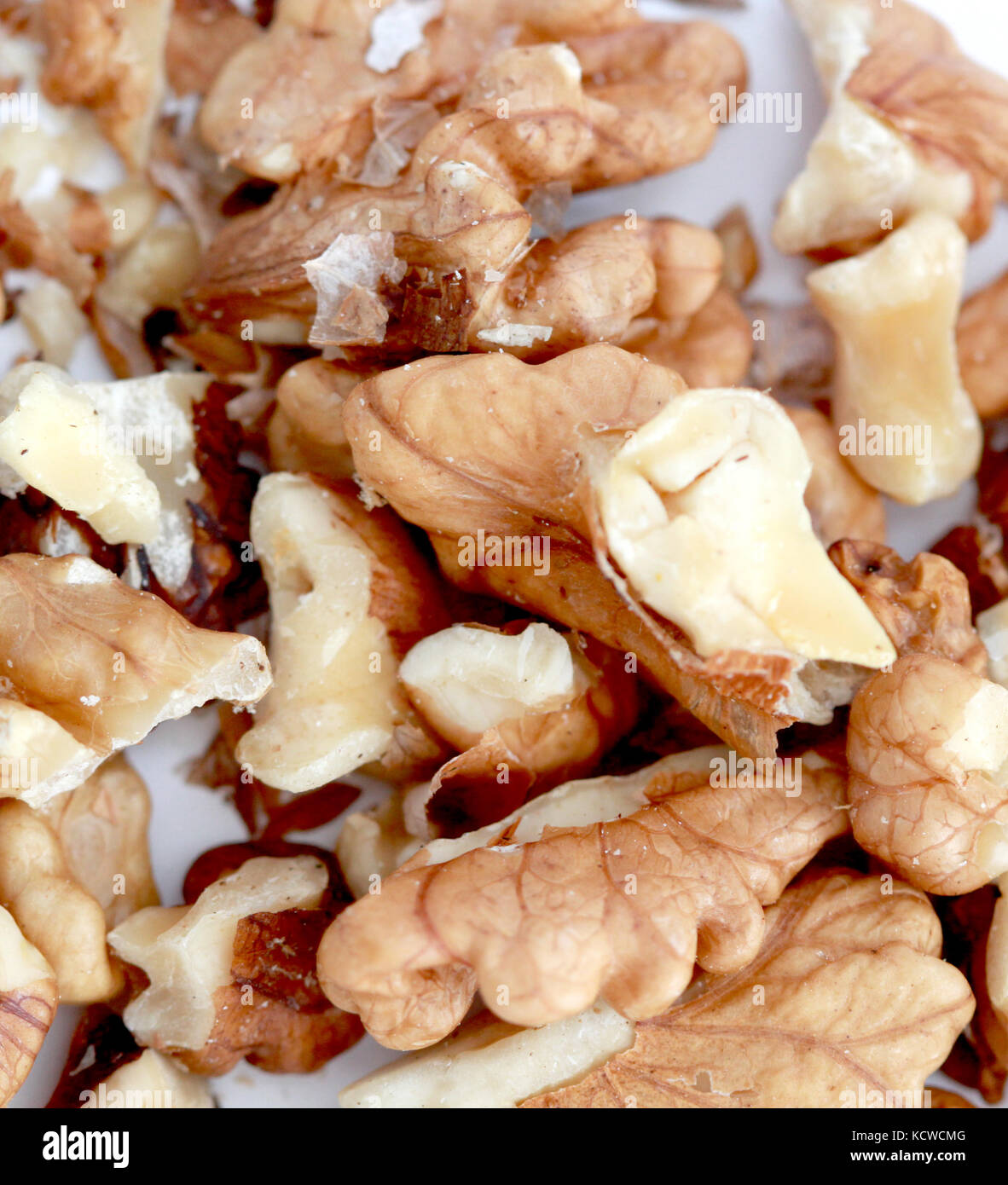 crushed walnuts on white background,image of a Stock Photo - Alamy