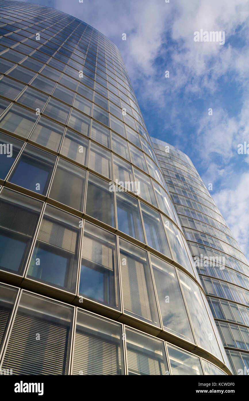 Glass modern building on a blue cloudy sky Stock Photo - Alamy