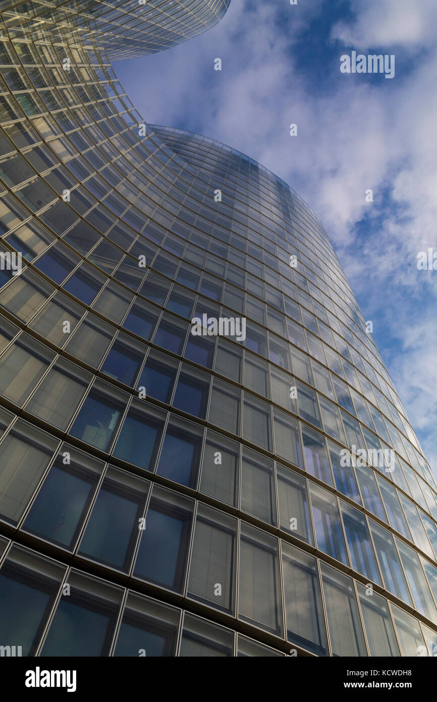 Glass modern building on a blue cloudy sky Stock Photo - Alamy