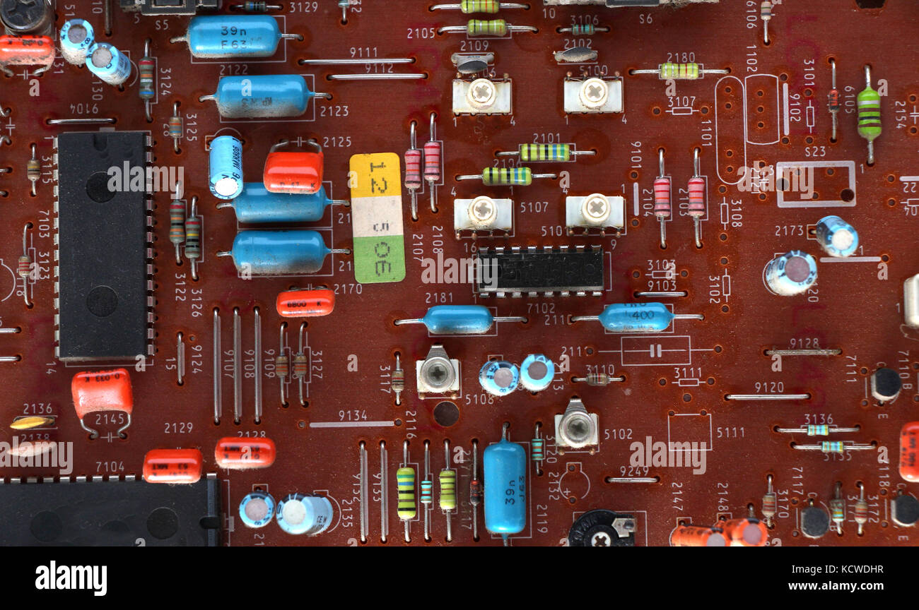 Part of old vintage printed circuit board with electronic components ...