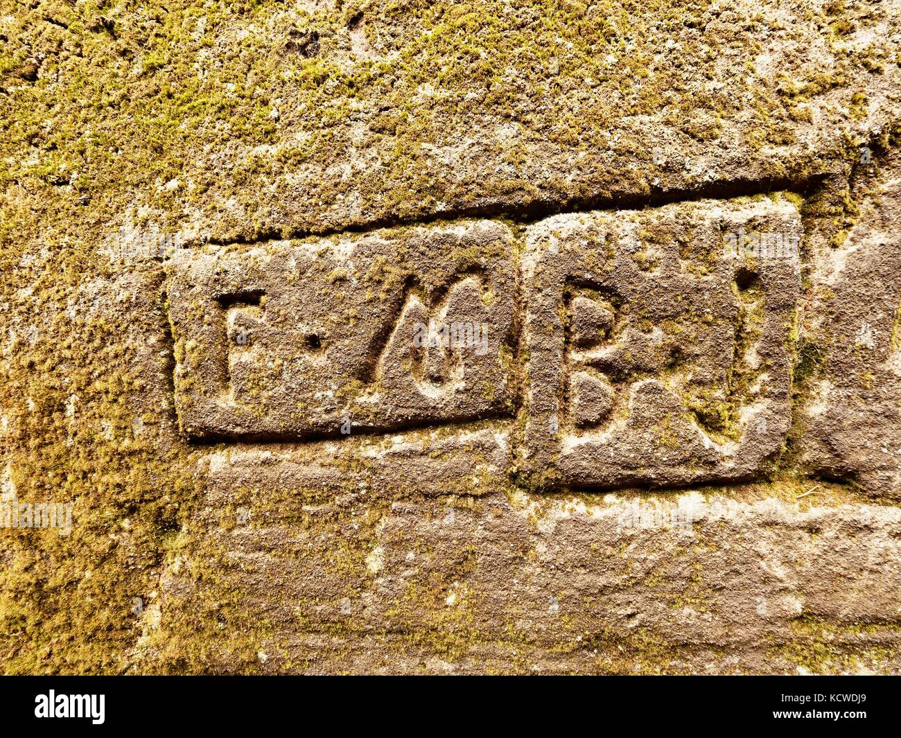 Ancient gray stone wall with carved inscriptions. Sandstone Wall with ...