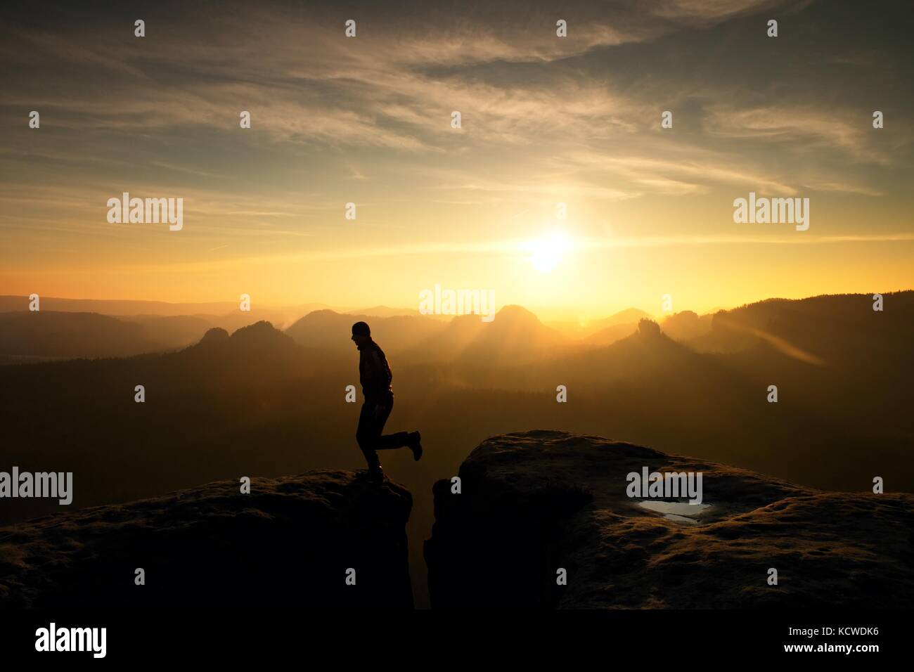 Jumping man. Young man makes jump on colorful sky background in ...