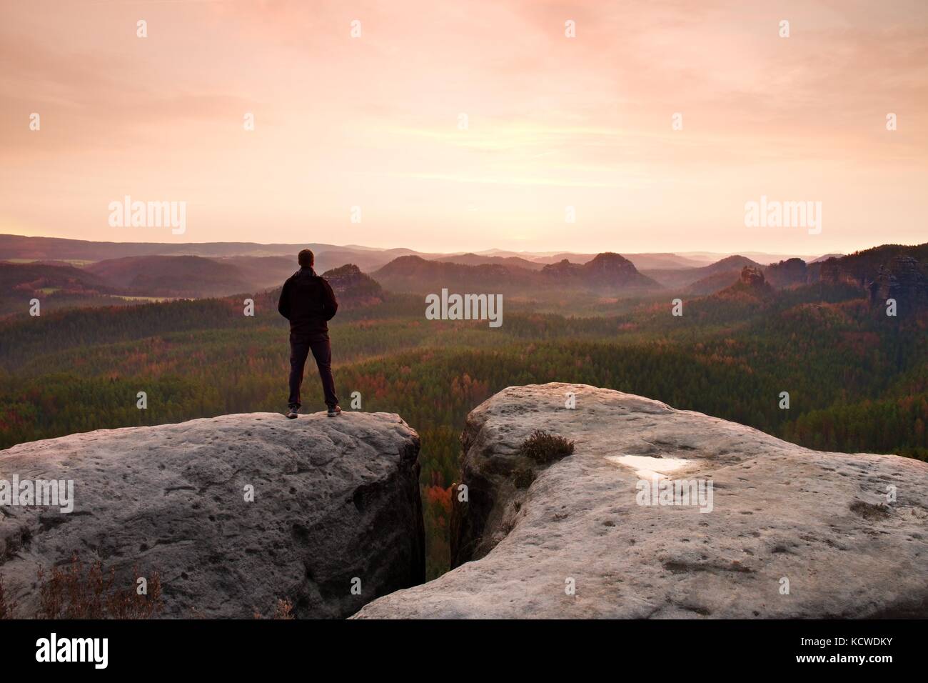 Hiker on the peak of sandstone rock in rock empires park and watching ...