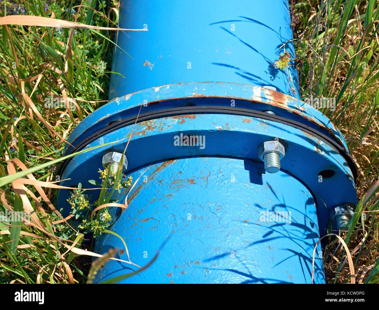 Repaired big drink water pipes joined with new blue flanges and silver ...