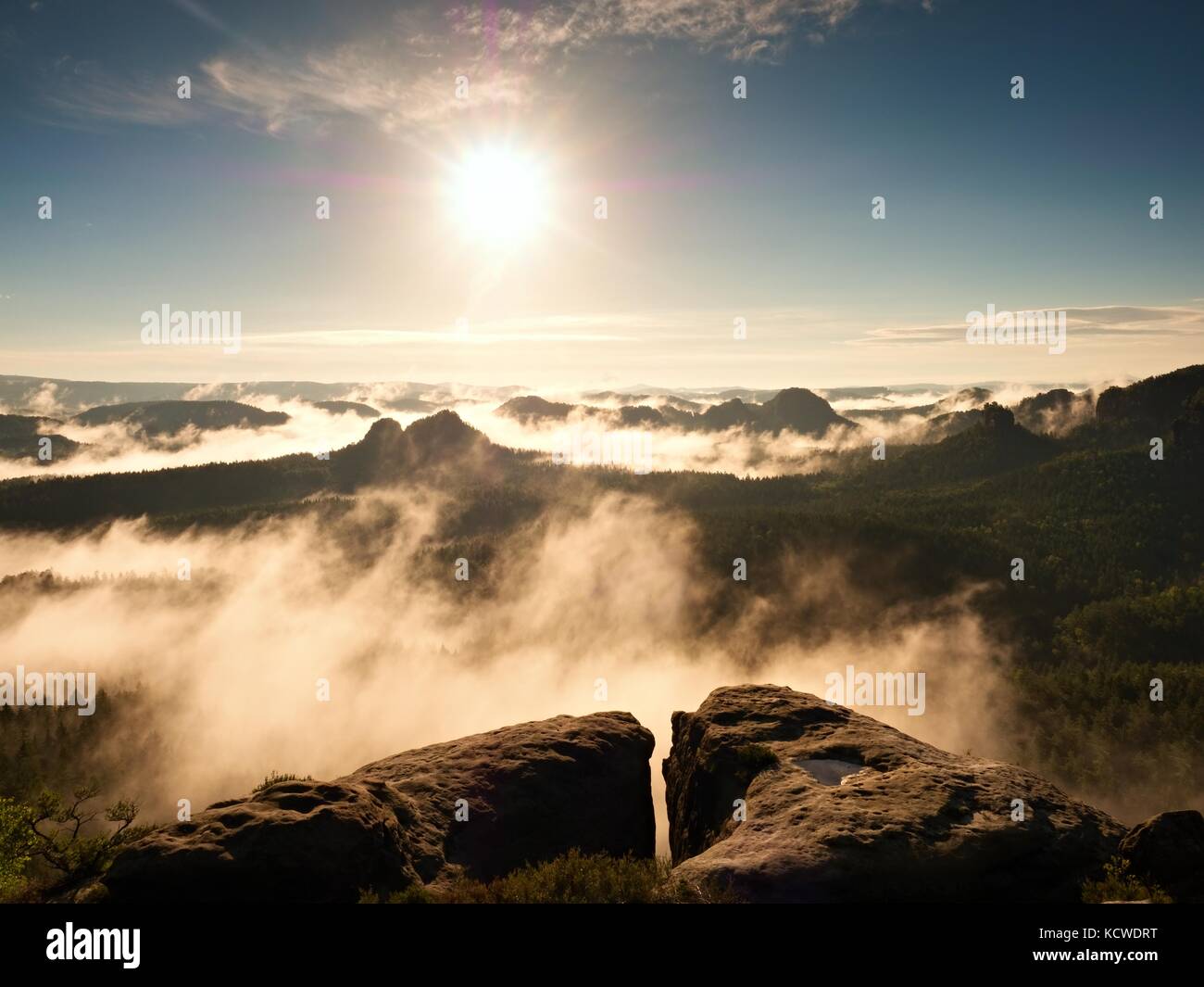 Morning view over sandstone cliff into forest valley, daybreak Sun at ...