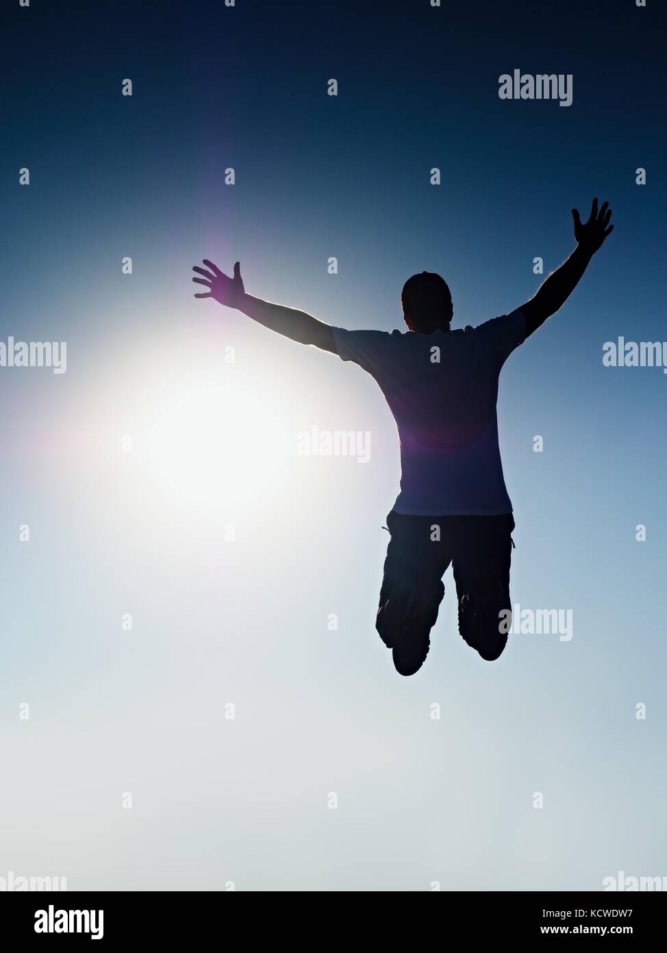 Man fly in air. Blue Toned effect. Man falling down with raised arms ...