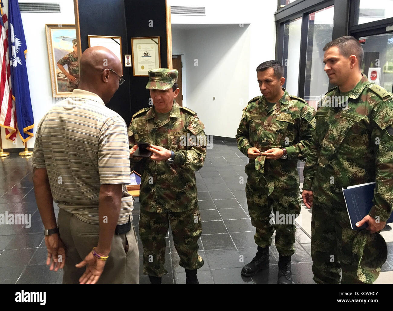 Colombian Army Major General Marco Lino Tamayo Tamayo presents a token ...
