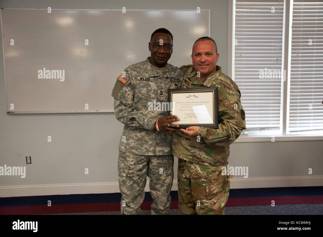 U.S. Army Lt. Col. Robert Downs presents Master Sgt. Theodore Wilder ...