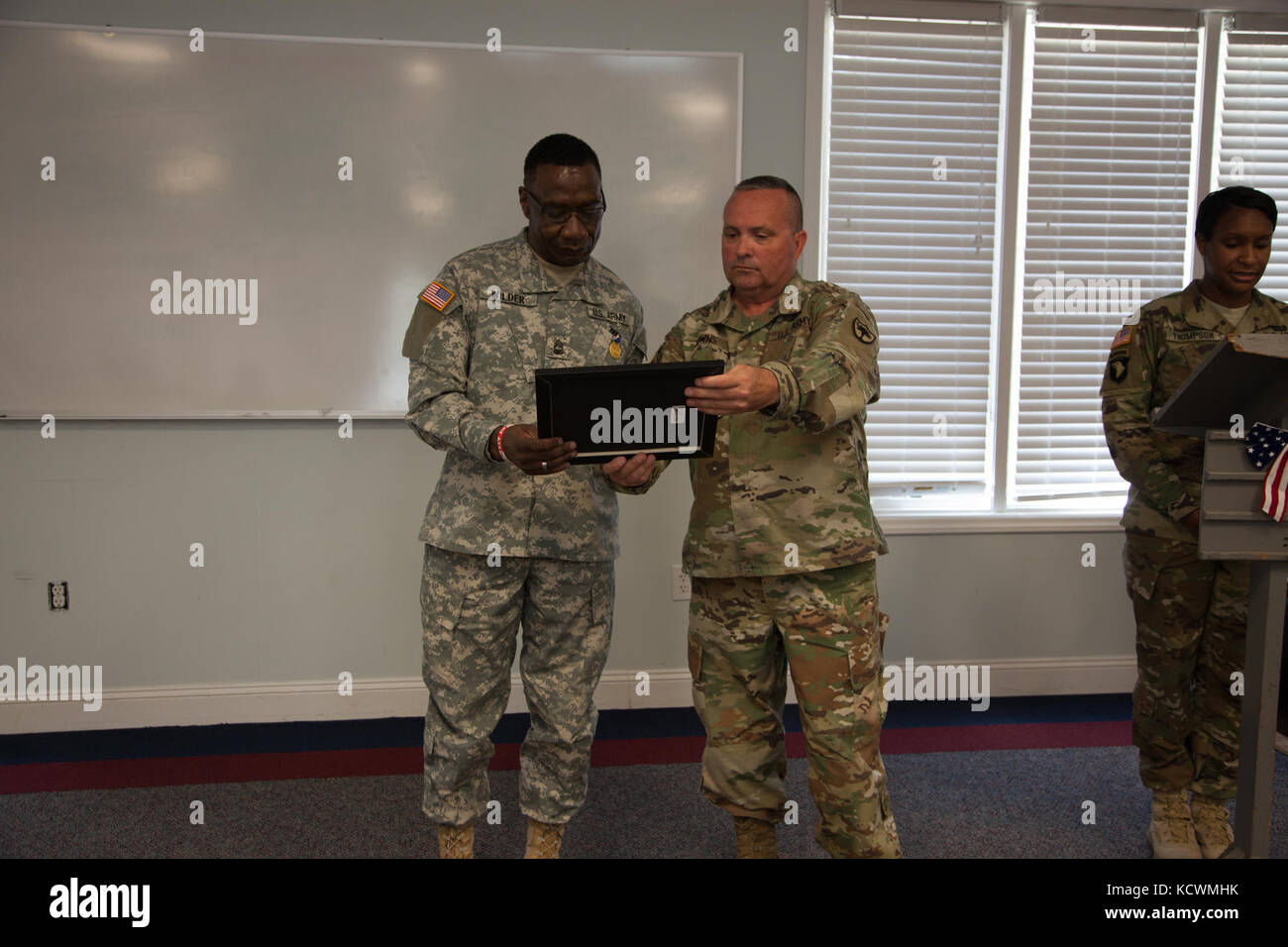 U.S. Army Lt. Col. Robert Downs presents Master Sgt. Theodore Wilder ...