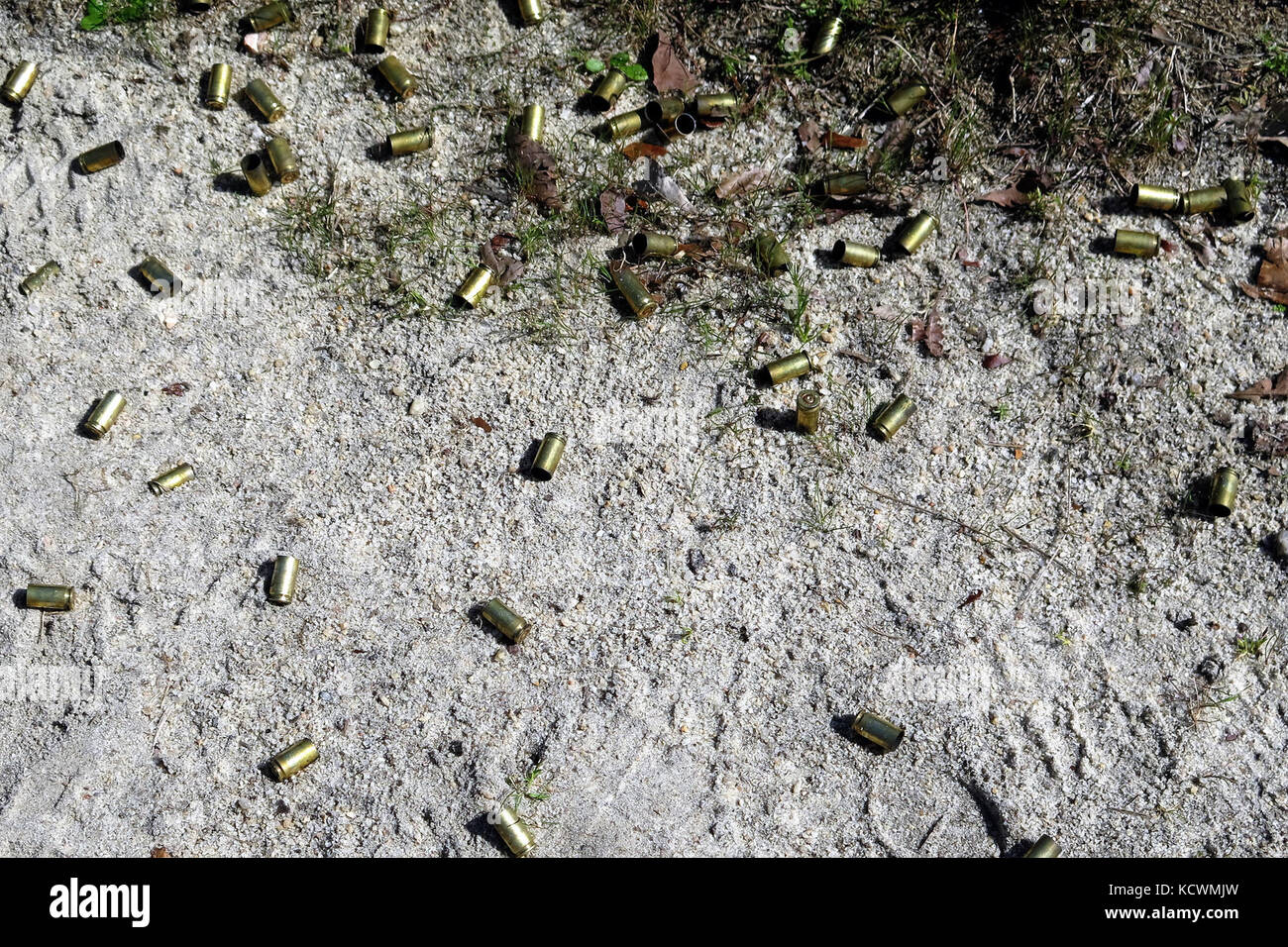 9mm shell casing fall to the sand on the weapons range. U.S. Soldiers ...