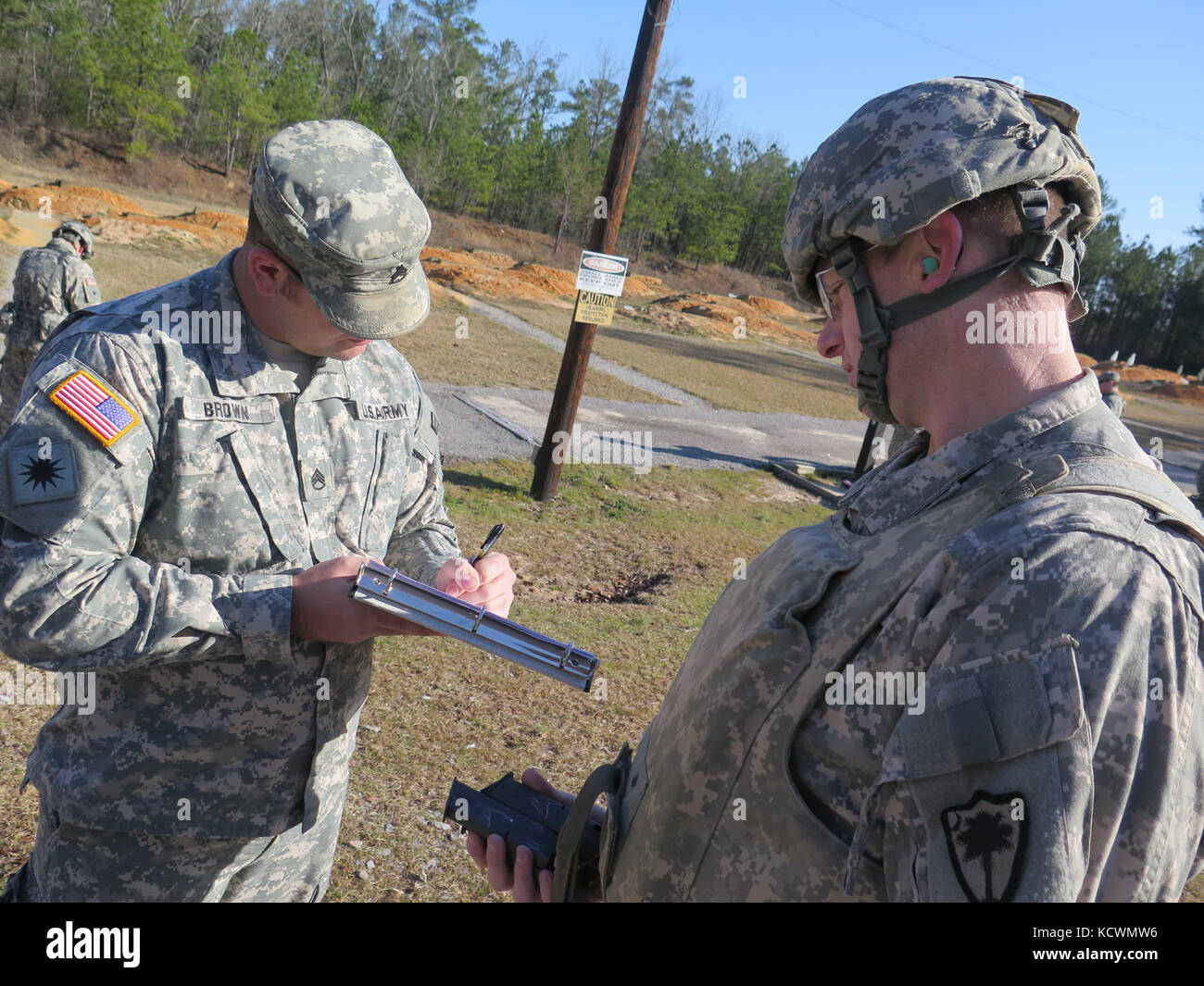 A score keeper at a weapons range takes names of participants before ...