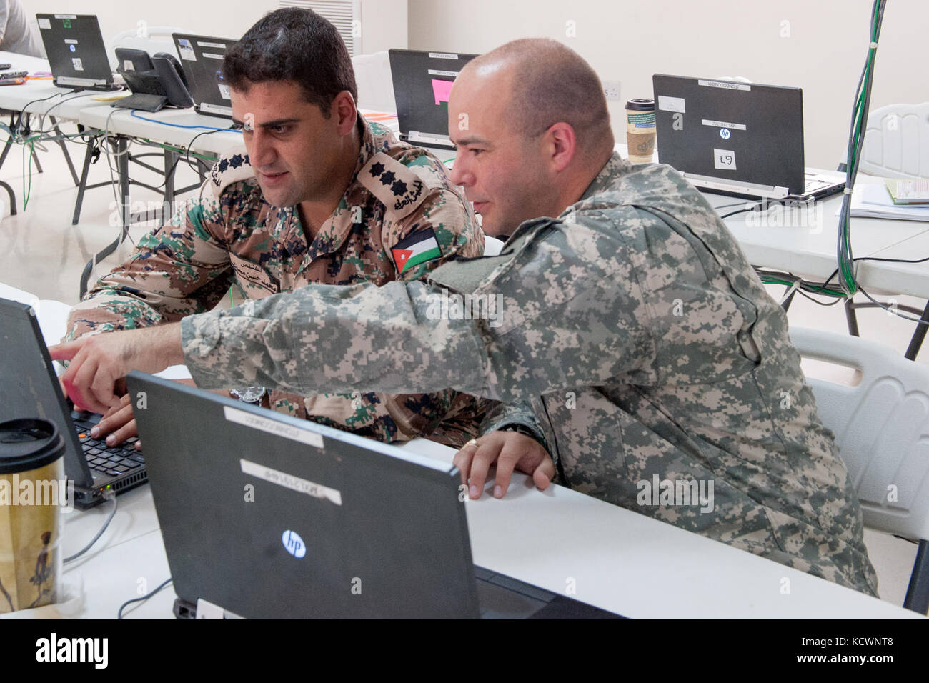 U.S. Army Sgt. 1st Class Tim Larkin, works with his Jordanian Armed ...