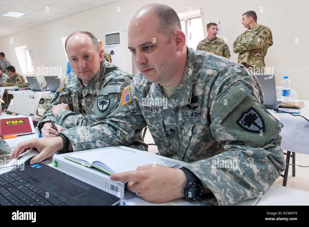 U.S. Army Lt. Col. Larry Saunders and Staff Sgt. Matthew Suddeth, work ...