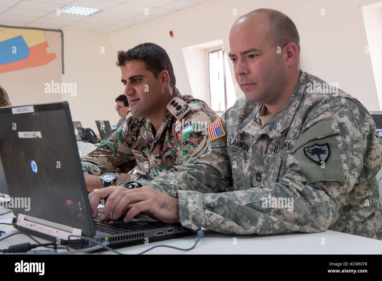 U.S. Army Sgt. 1st Class Tim Larkin, works with his Jordanian Armed ...