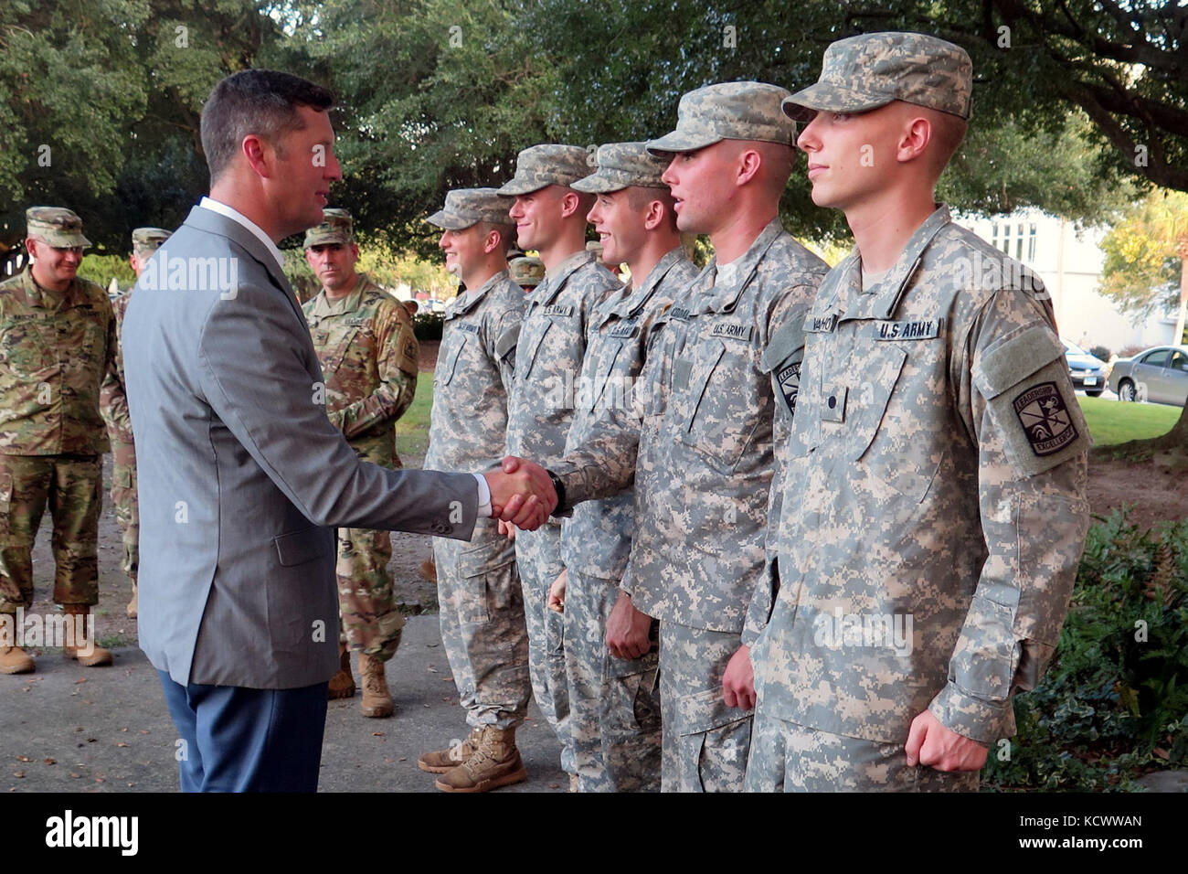 Under Secretary of the Army Mr. Patrick J. Murphy presents coins to ...