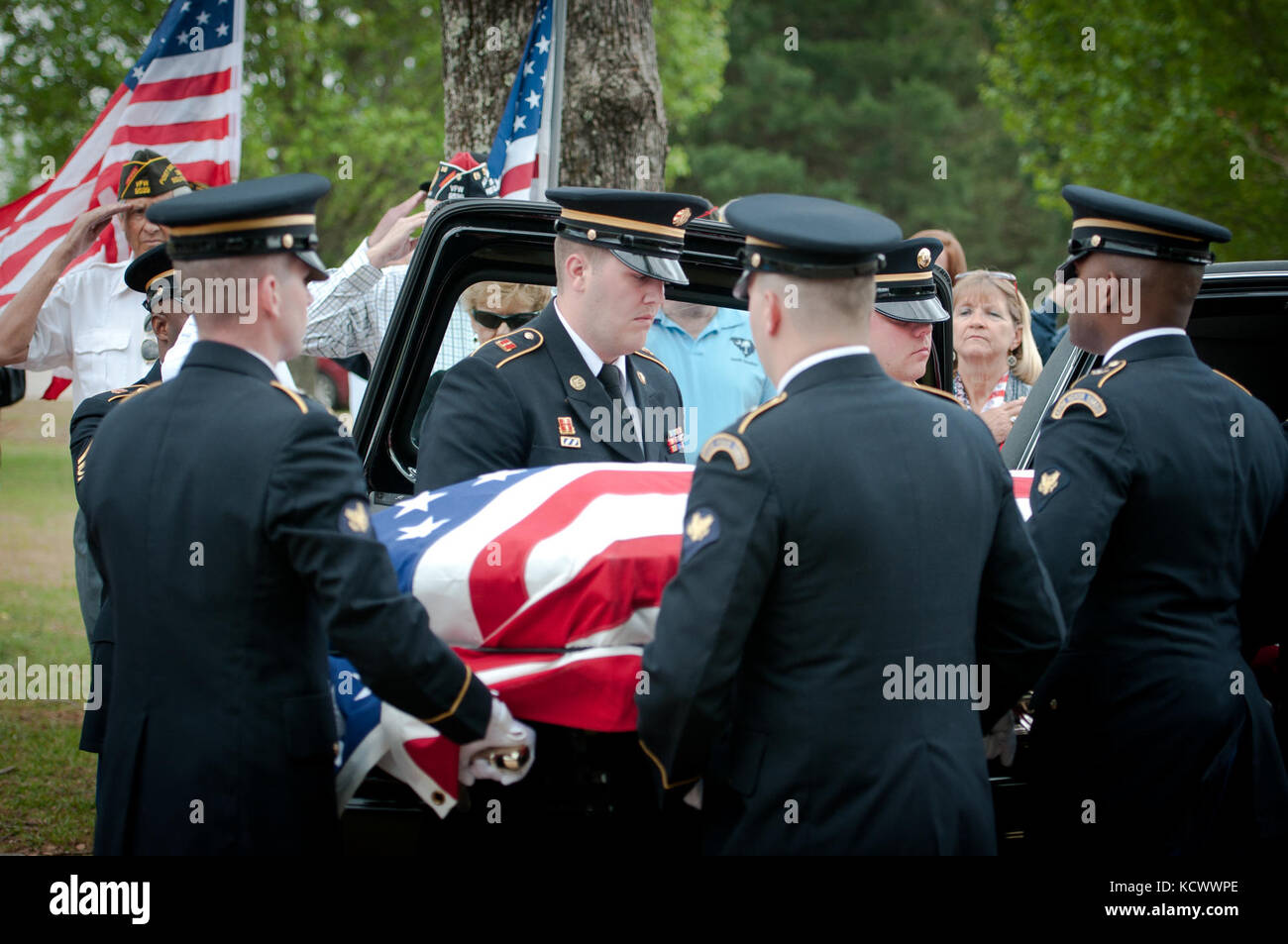 Survivors attend a funeral service held in honor of former U.S. Army ...