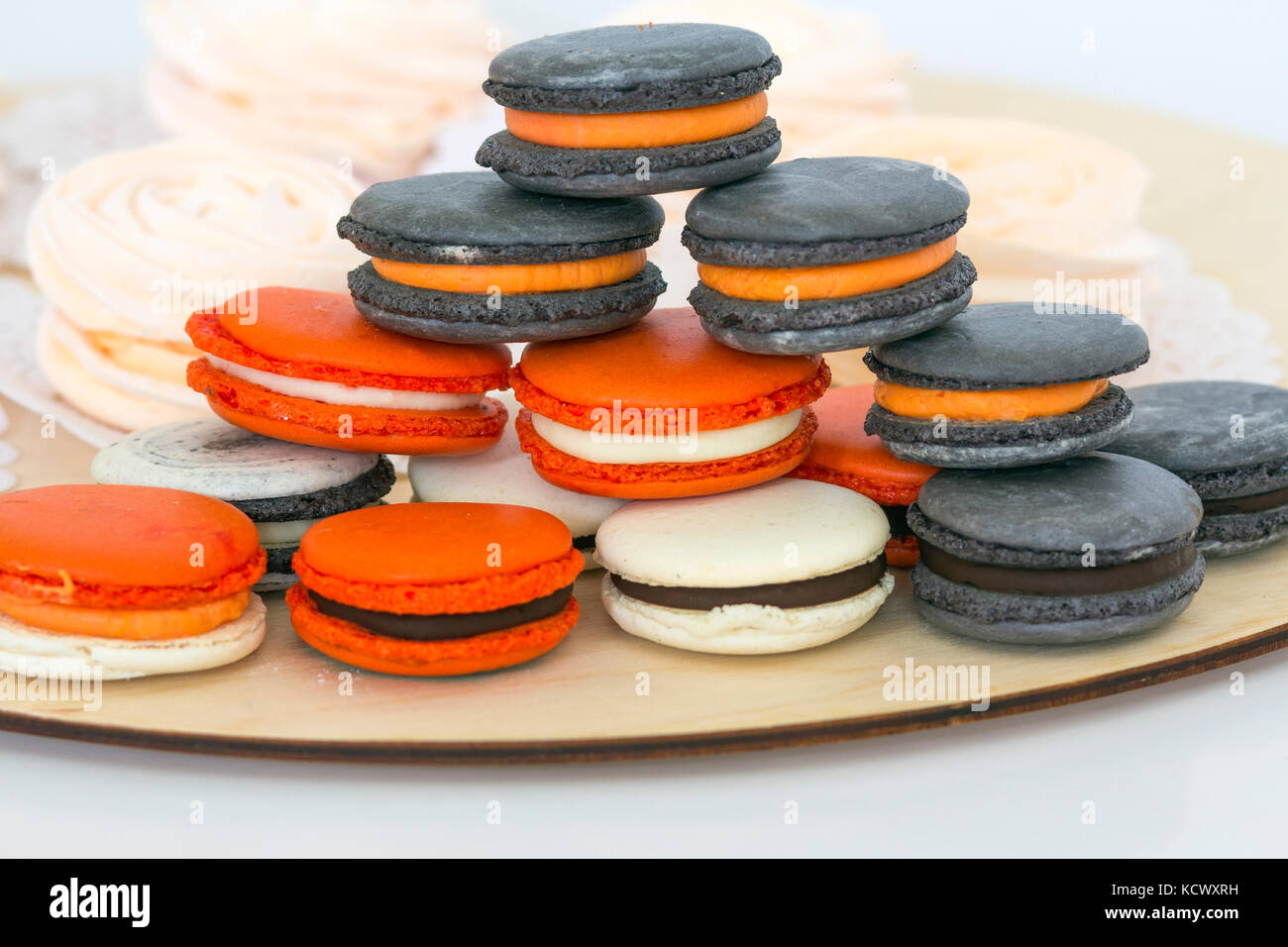 Different kinds of macaroons in stack on light background Stock Photo ...