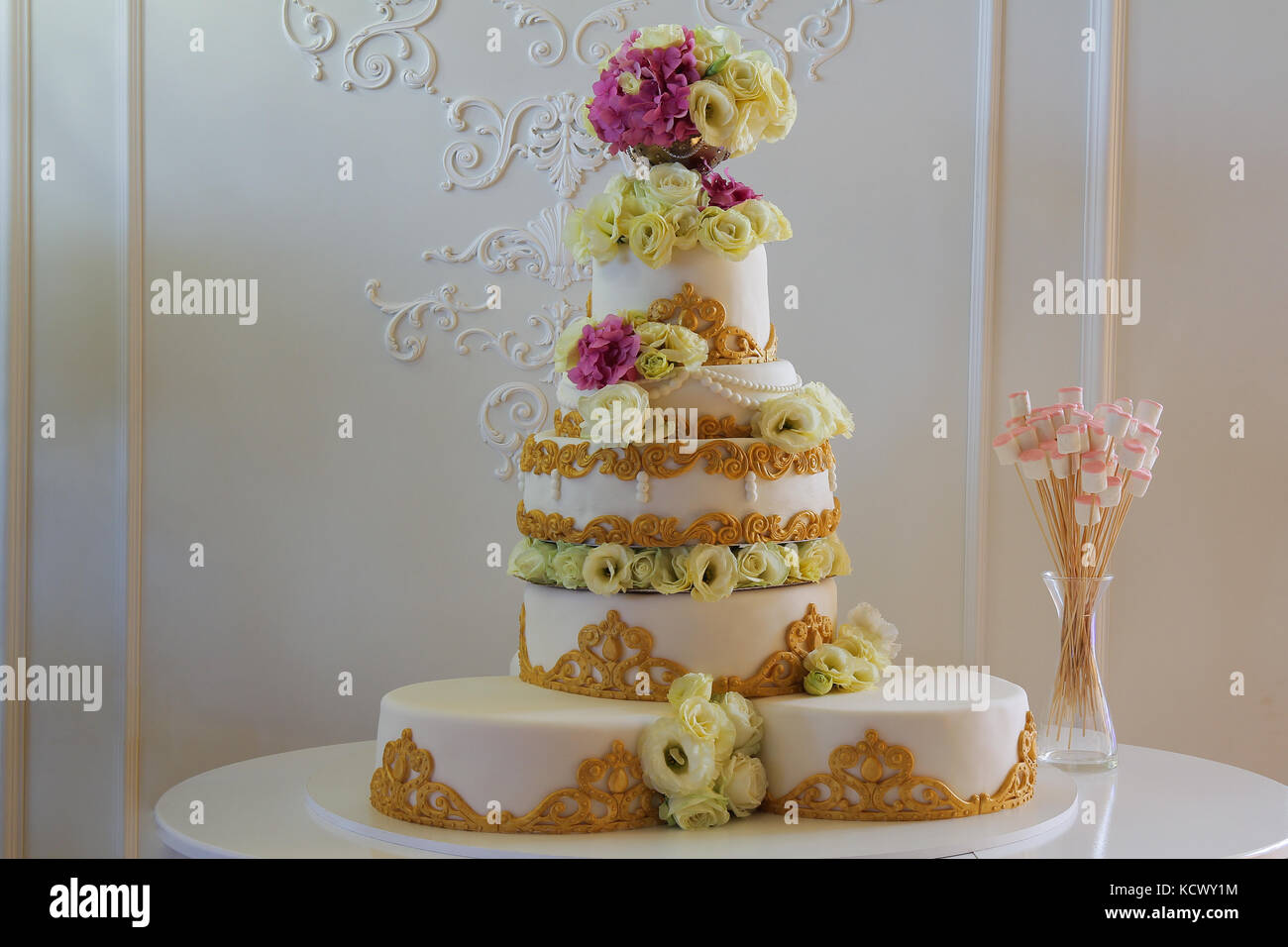 Big white wedding cake with flowers and ornaments Stock Photo - Alamy