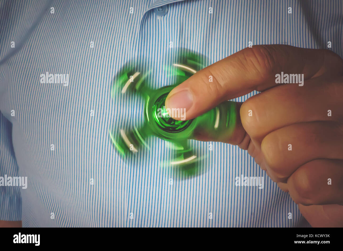 fingers of the men holding the spinner close up. A guy in a business ...