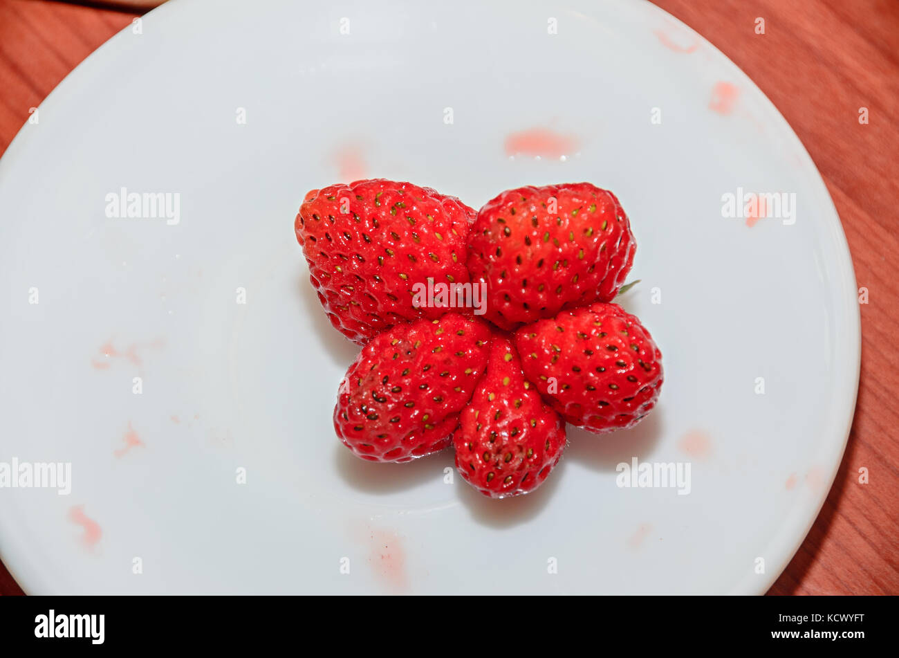 Star shape red strawberry fruit, white plate, close up Stock Photo - Alamy