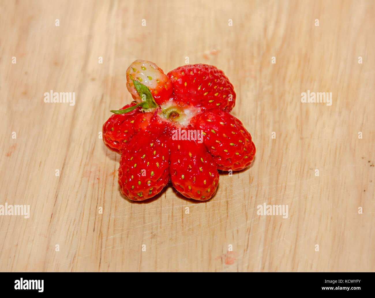 Star shape red strawberry fruit, rustic wood background, close up Stock ...