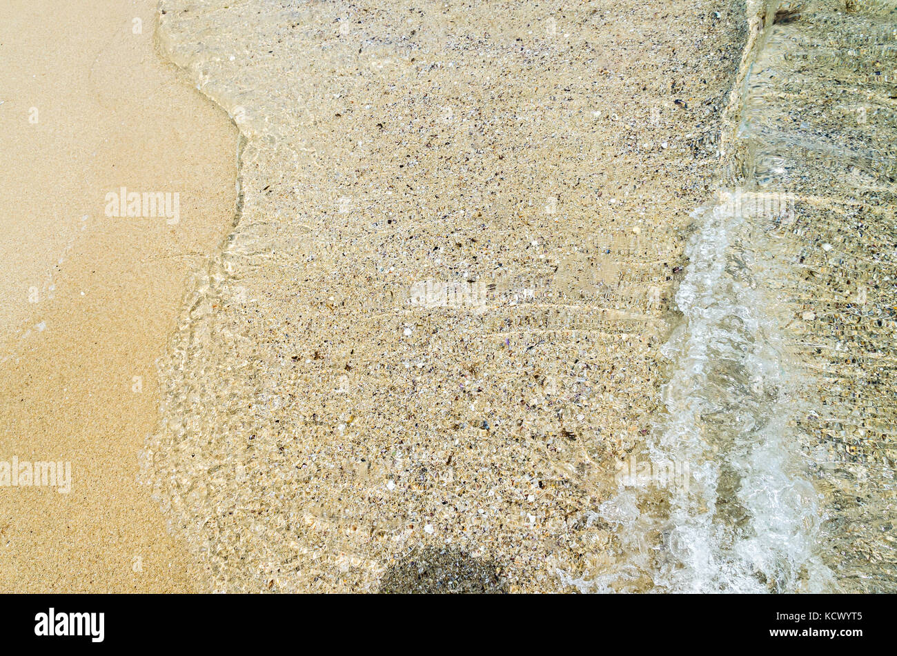 Beach sand with sea water, background texture close up, ocean shore ...
