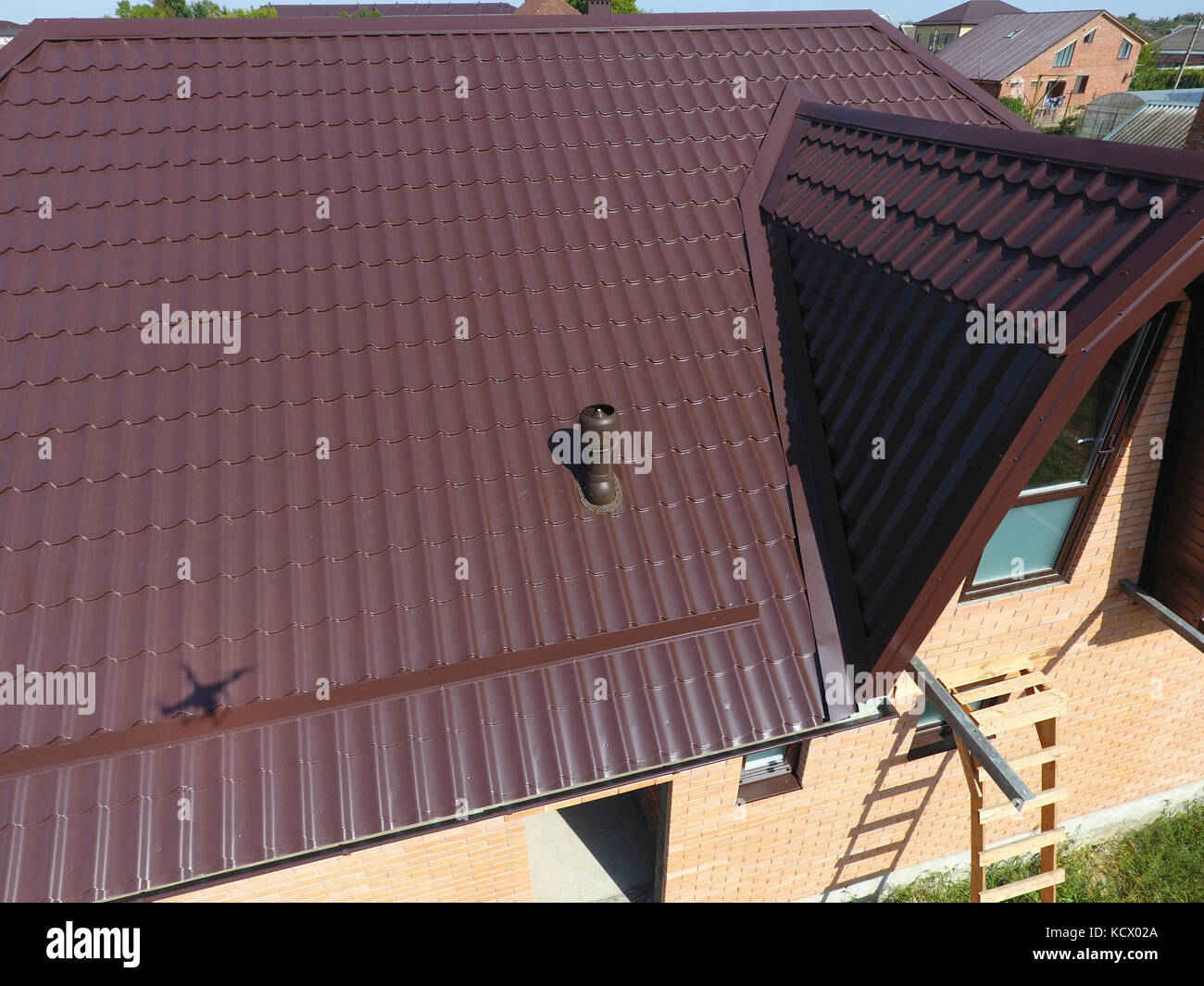 The roof of corrugated sheet. Roofing of metal profile wavy shape. A ...