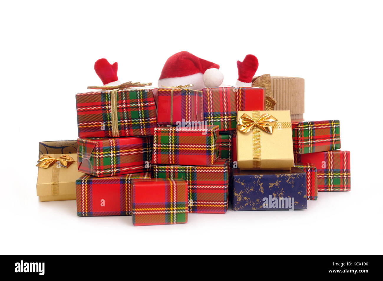 Santa claus overwhelmed by pile of christmas presents over white ...