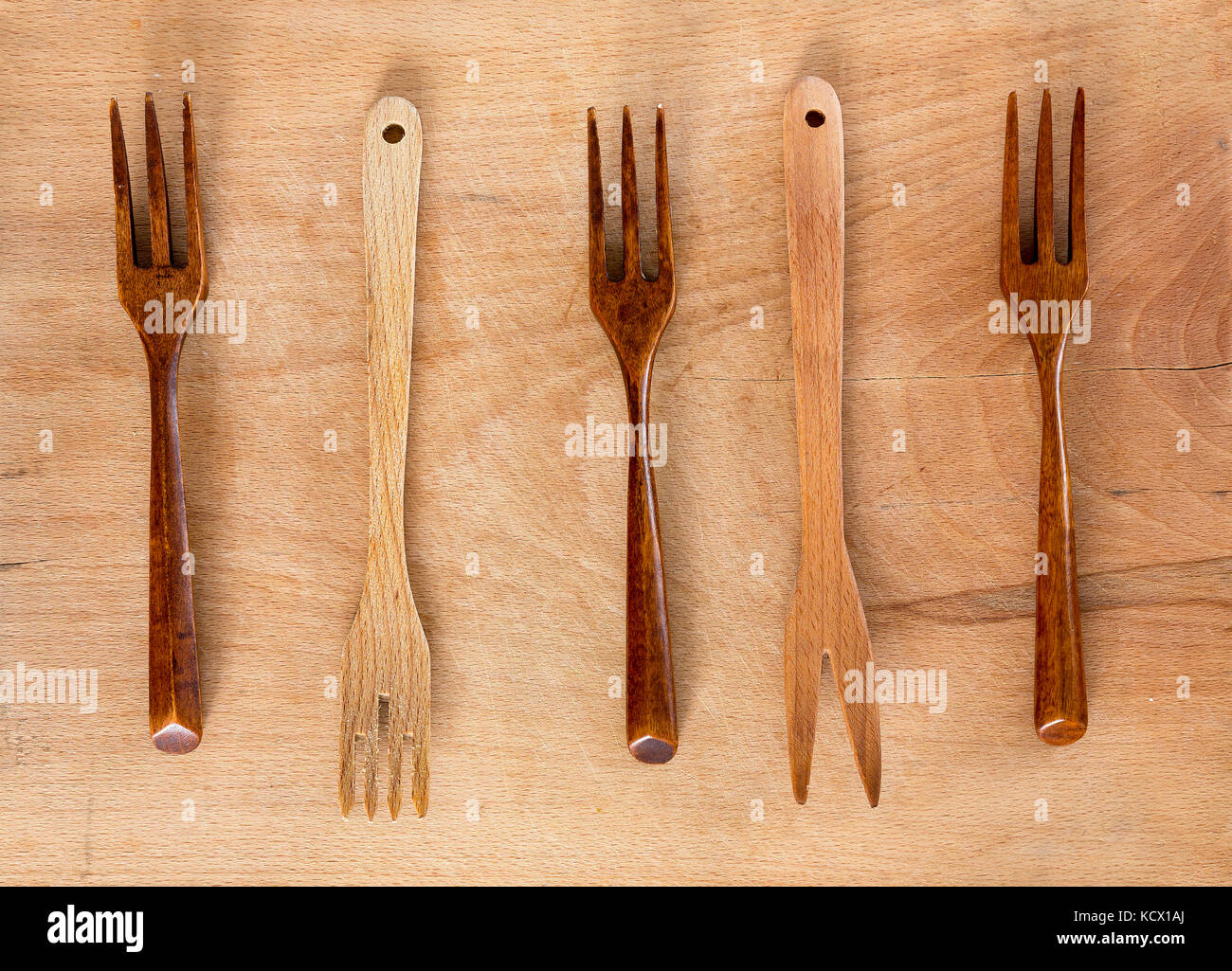 Wooden forks on a wooden background from above. Studio shot. Kitchen ...